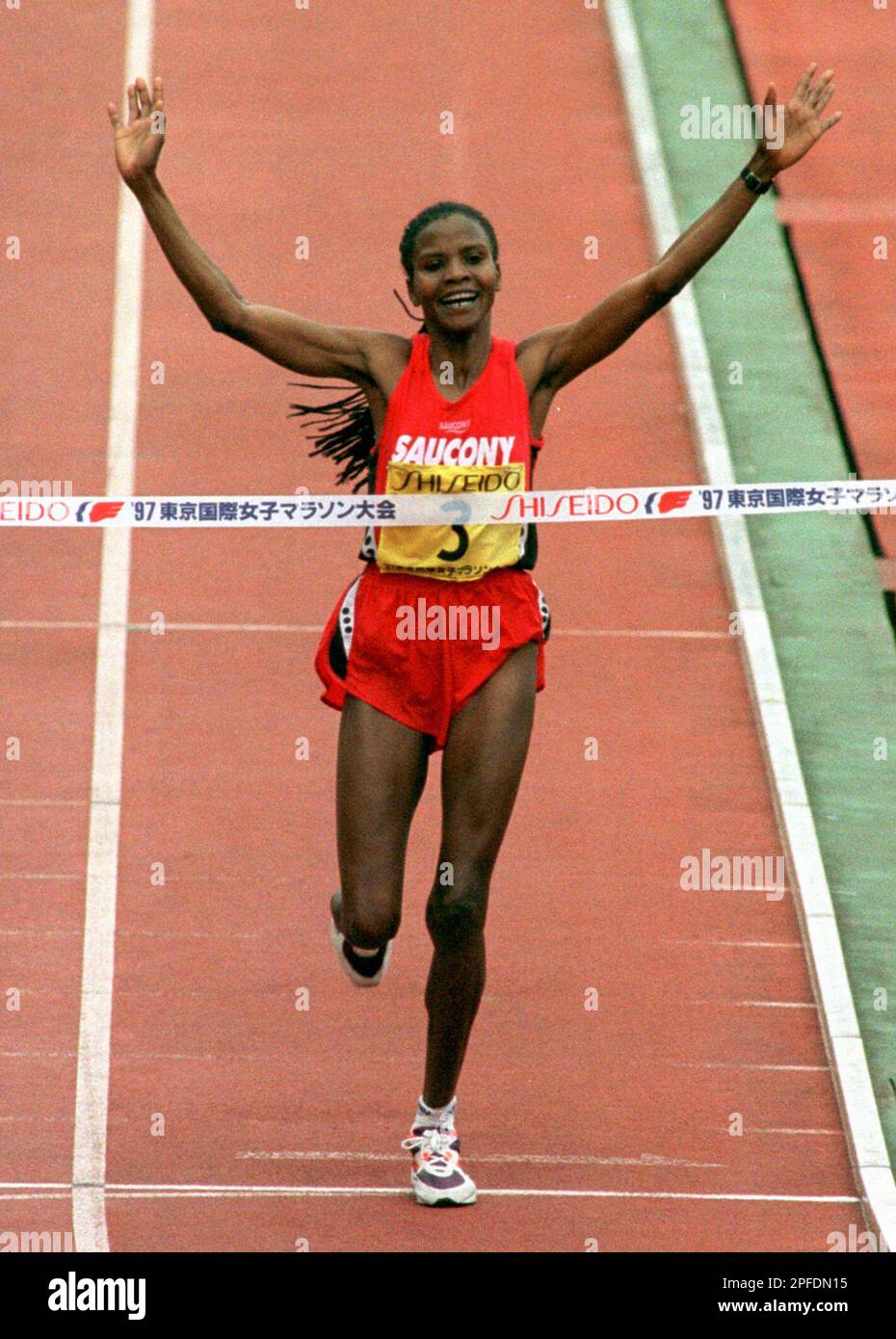 Joyce Chepchumba, from Kenya, raises her arms as she finishes second ...