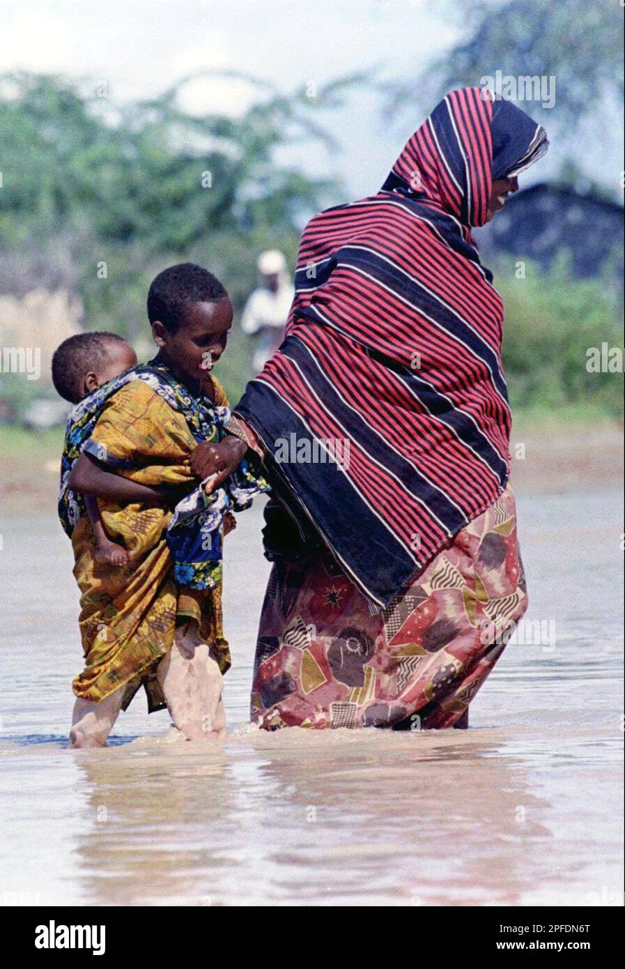 A Somali refugee walks with her two children Thursday, Nov.27 1997 ...