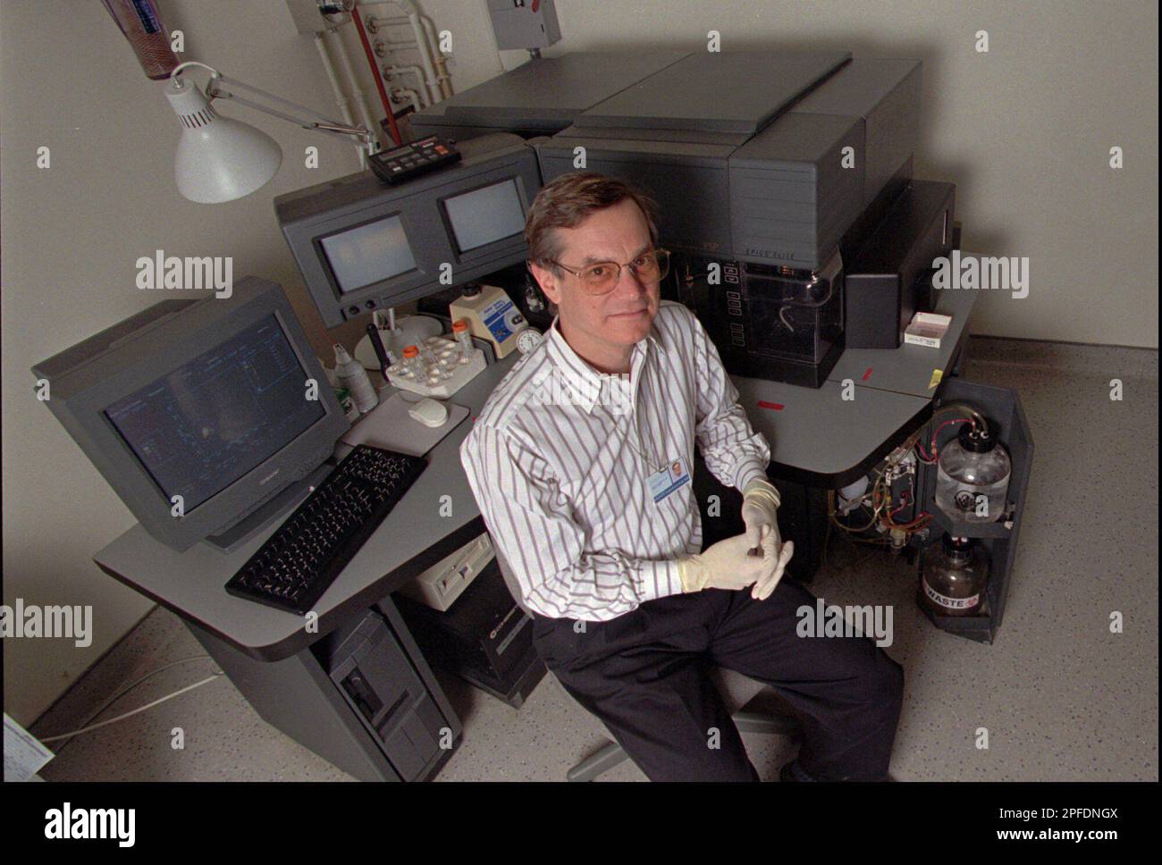 AIDS researcher Joseph Margolick sits in front of a flow cytometer, a ...