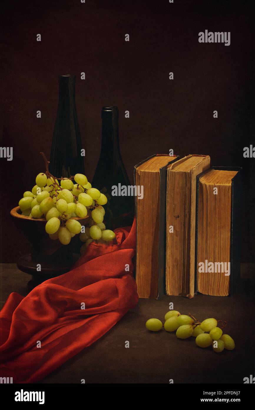 Still life with grapes, old books and bottles Stock Photo - Alamy