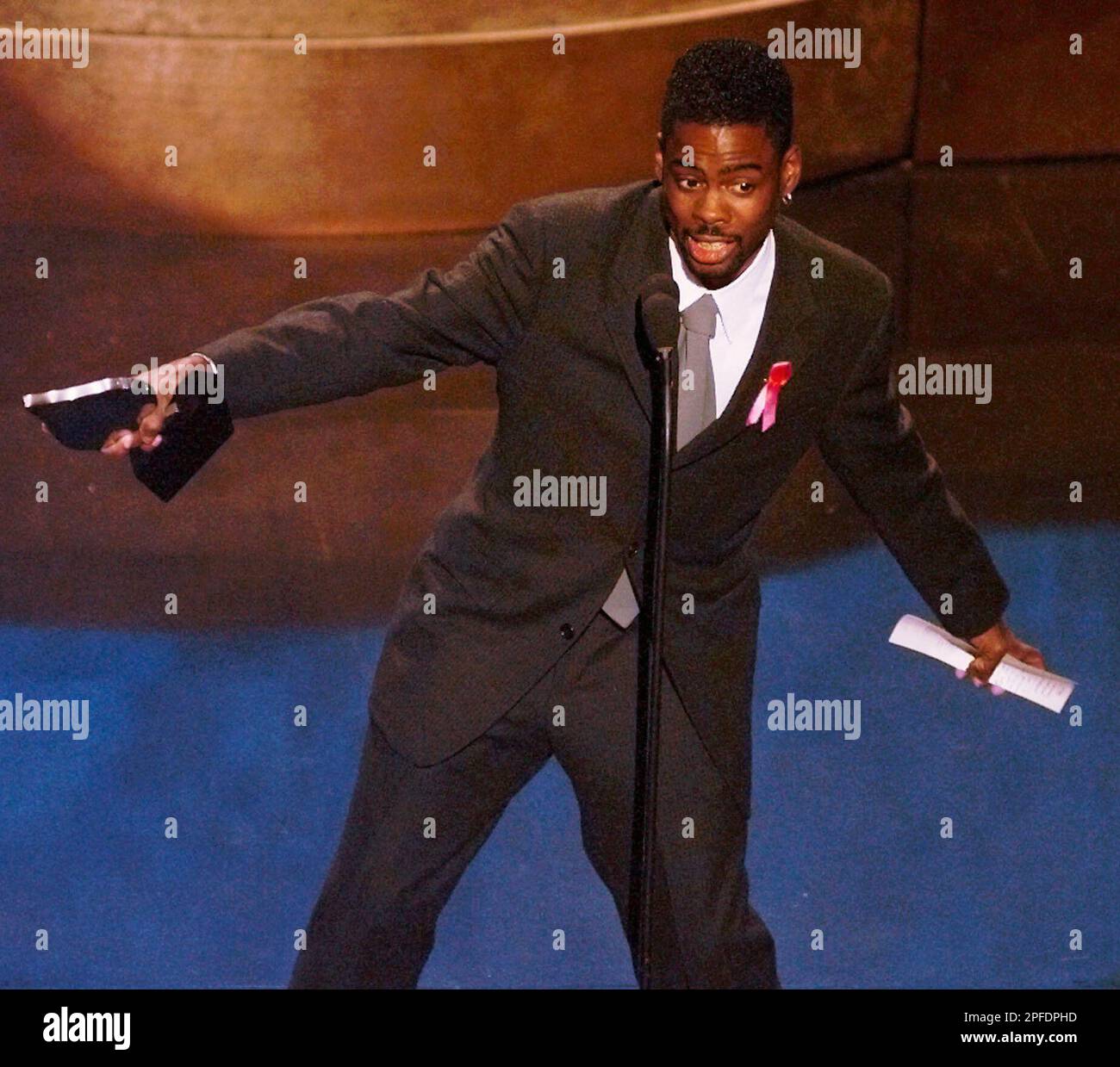 Comedian Chris Rock accepts his award for entertainment host during the ...