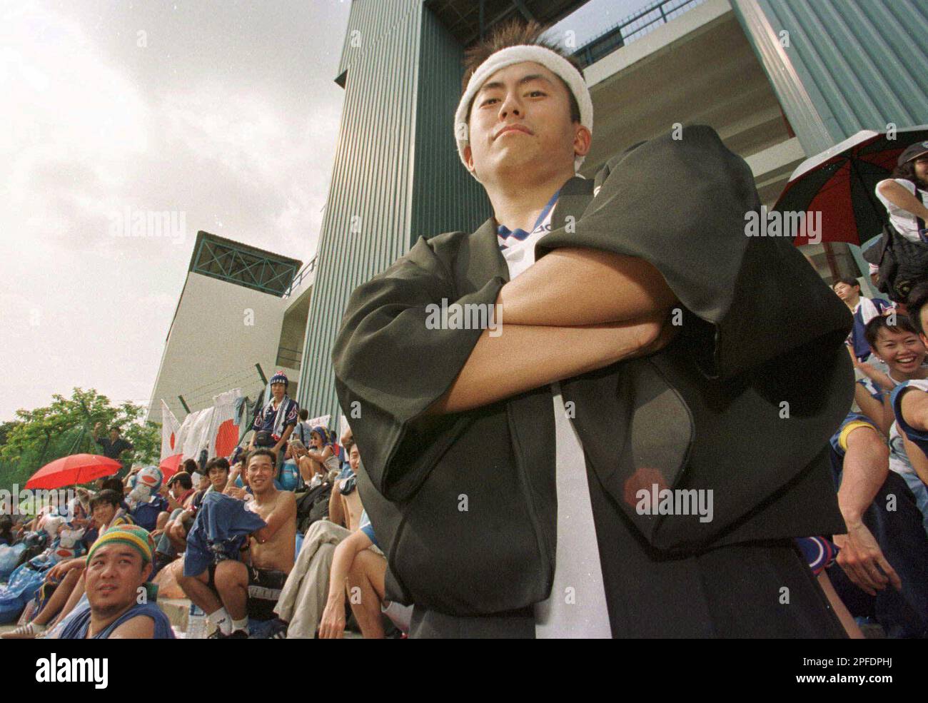 A Japanese soccer fan strikes a pose outside the Johor Bahru stadium ...