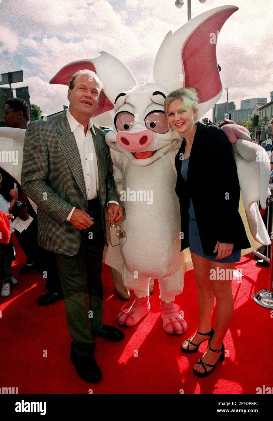 Kelsey Grammer, left, and Kirsten Dunst are embraced by Bartok, an ...