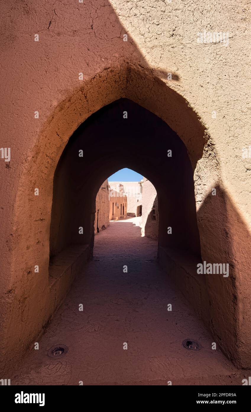 Archway in the abandoned mud brick village of Harat al Bilad, Manah ...