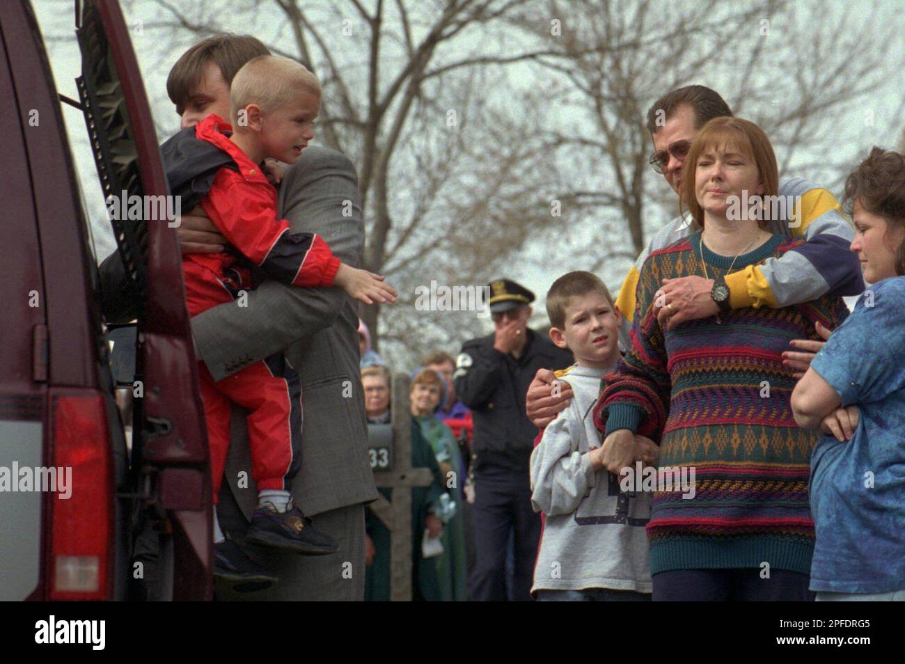 Jay Warburton puts an arm around his wife, Kimberly, as biological ...