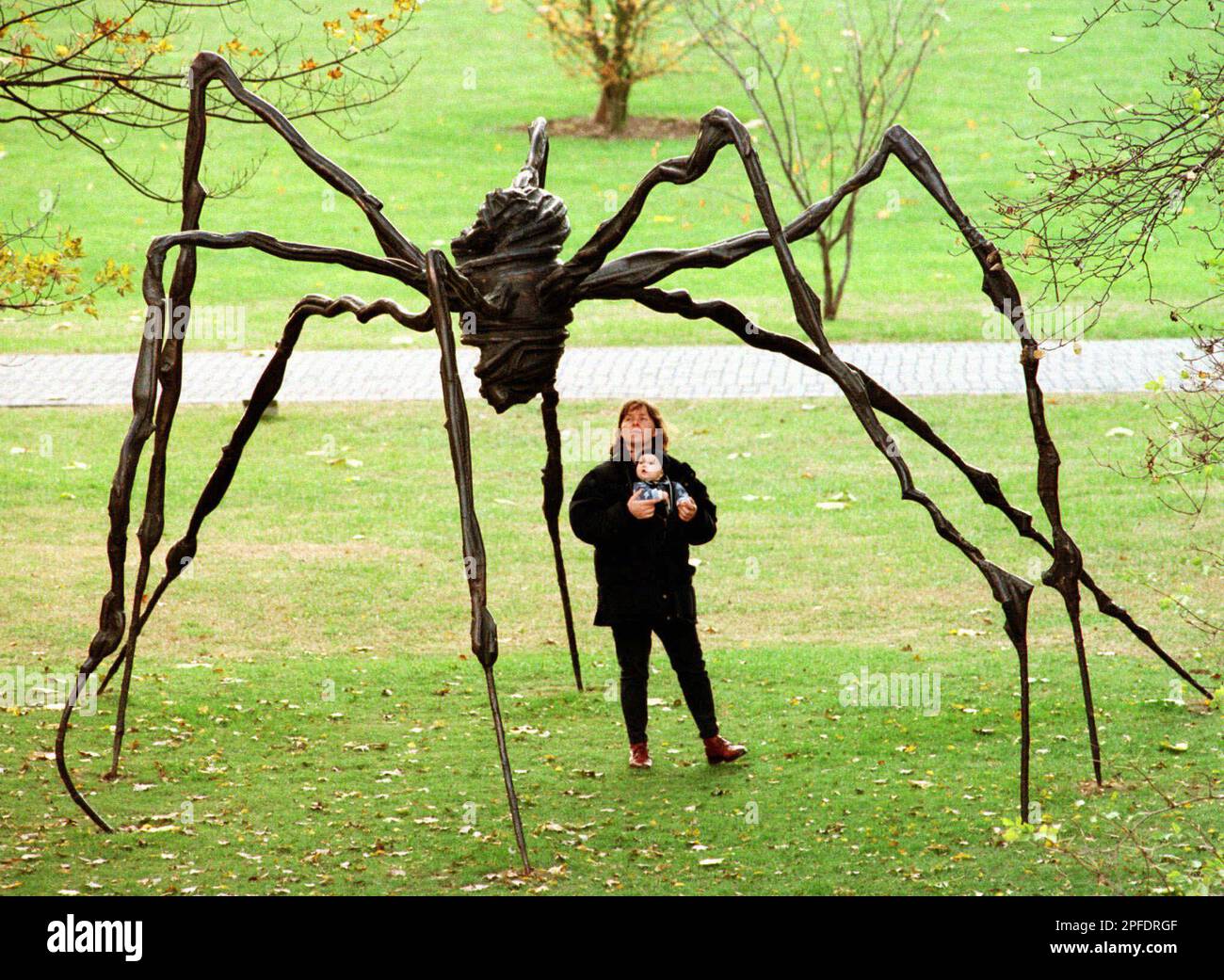A mother with her baby examines the sculpture "Spider" by French artist ...