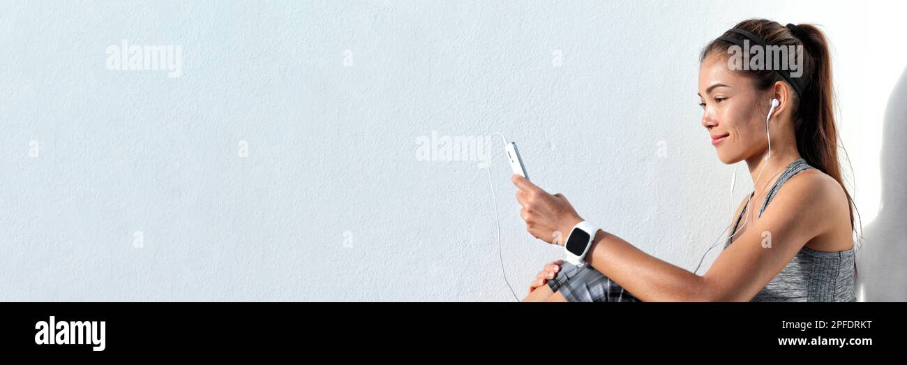 Sports wearable tech devices fit Asian girl using phone listening to ...