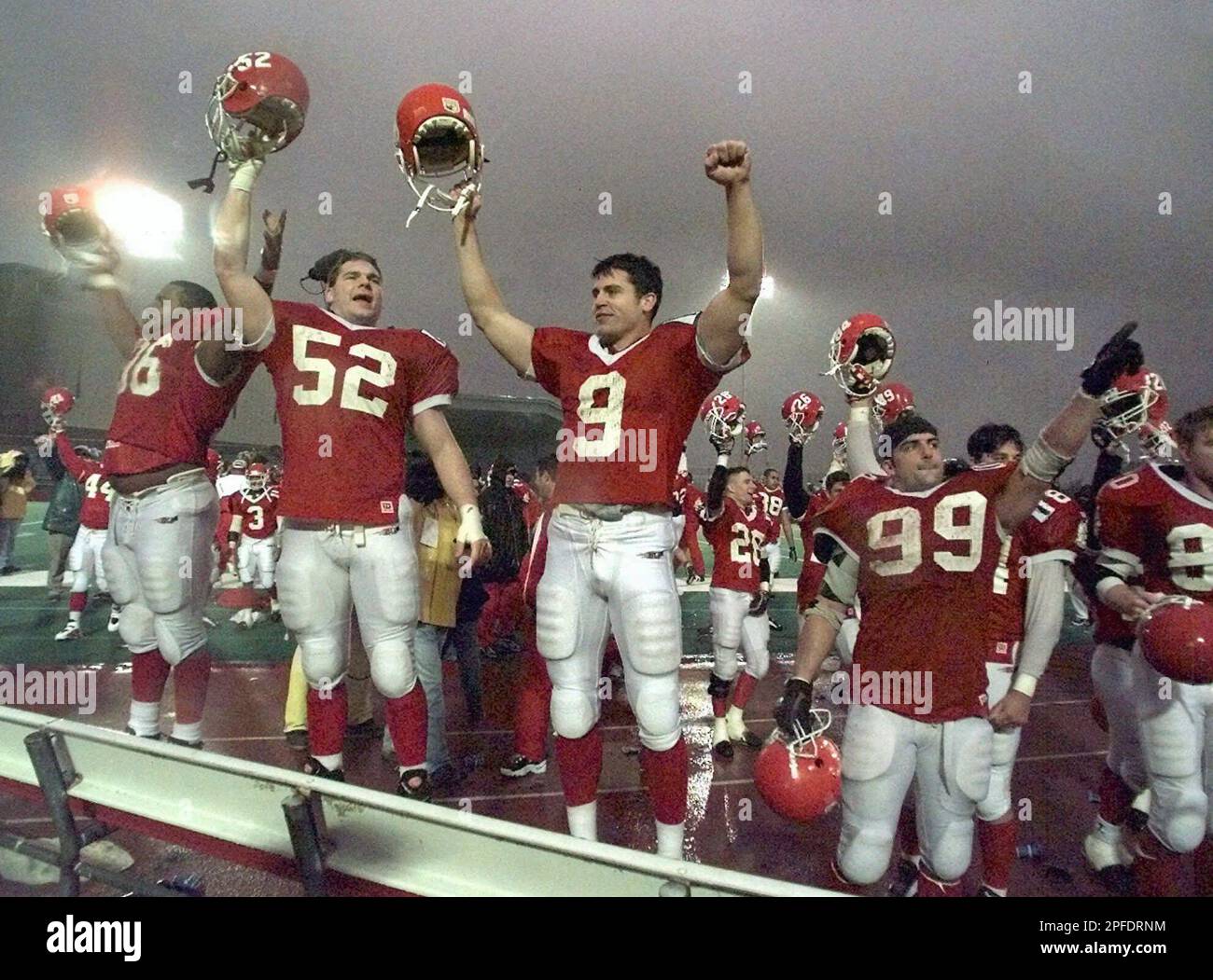Members of the Boston University football team cheer for their fans ...