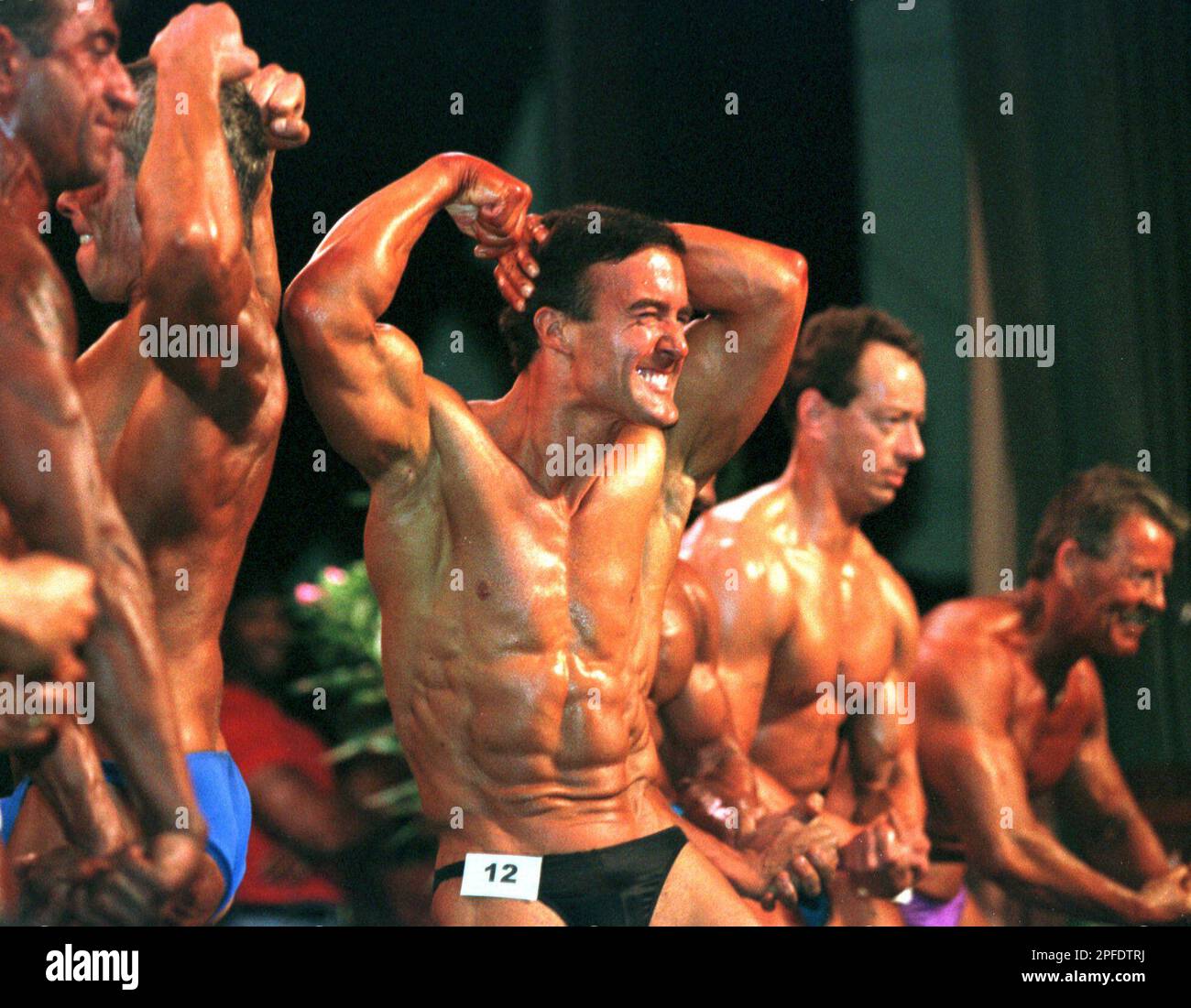 Tom Ricci, (12), smiles as he flexes for the judges during the third ...