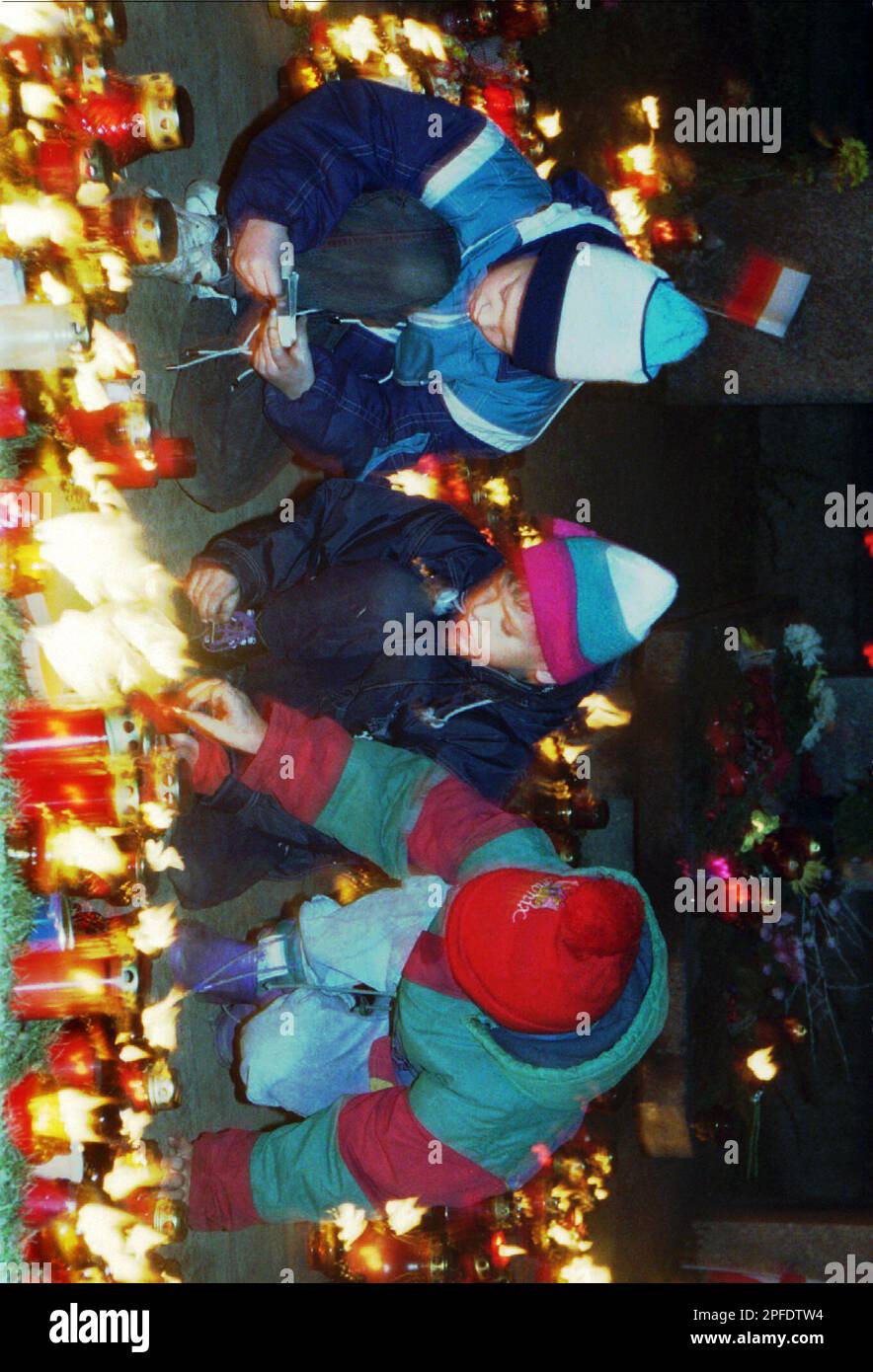 On All Saints' Day children light candles at the monument of Polish ...