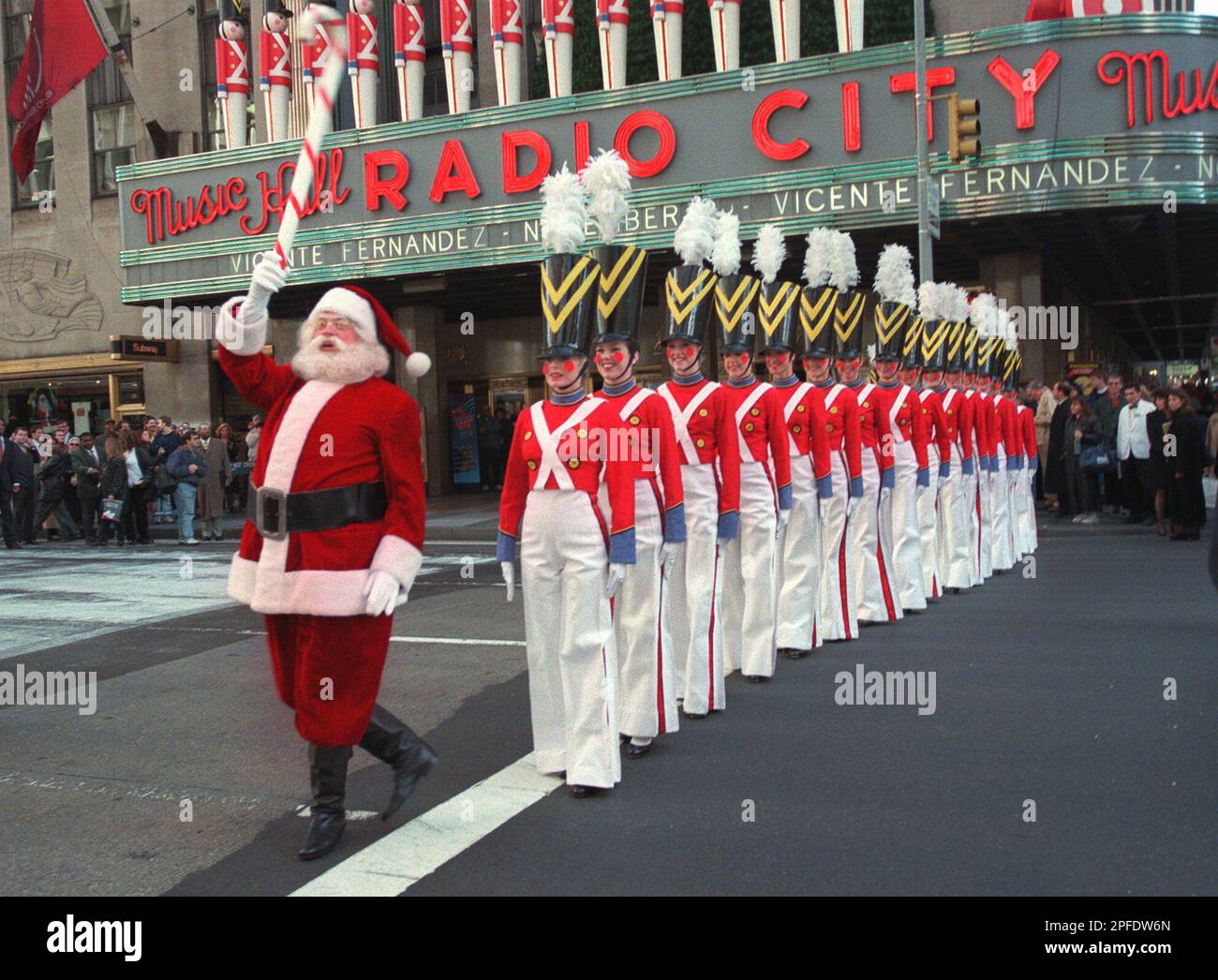 Santa Claus leads 26 Radio City Rockettes in wooden soldier costumes ...