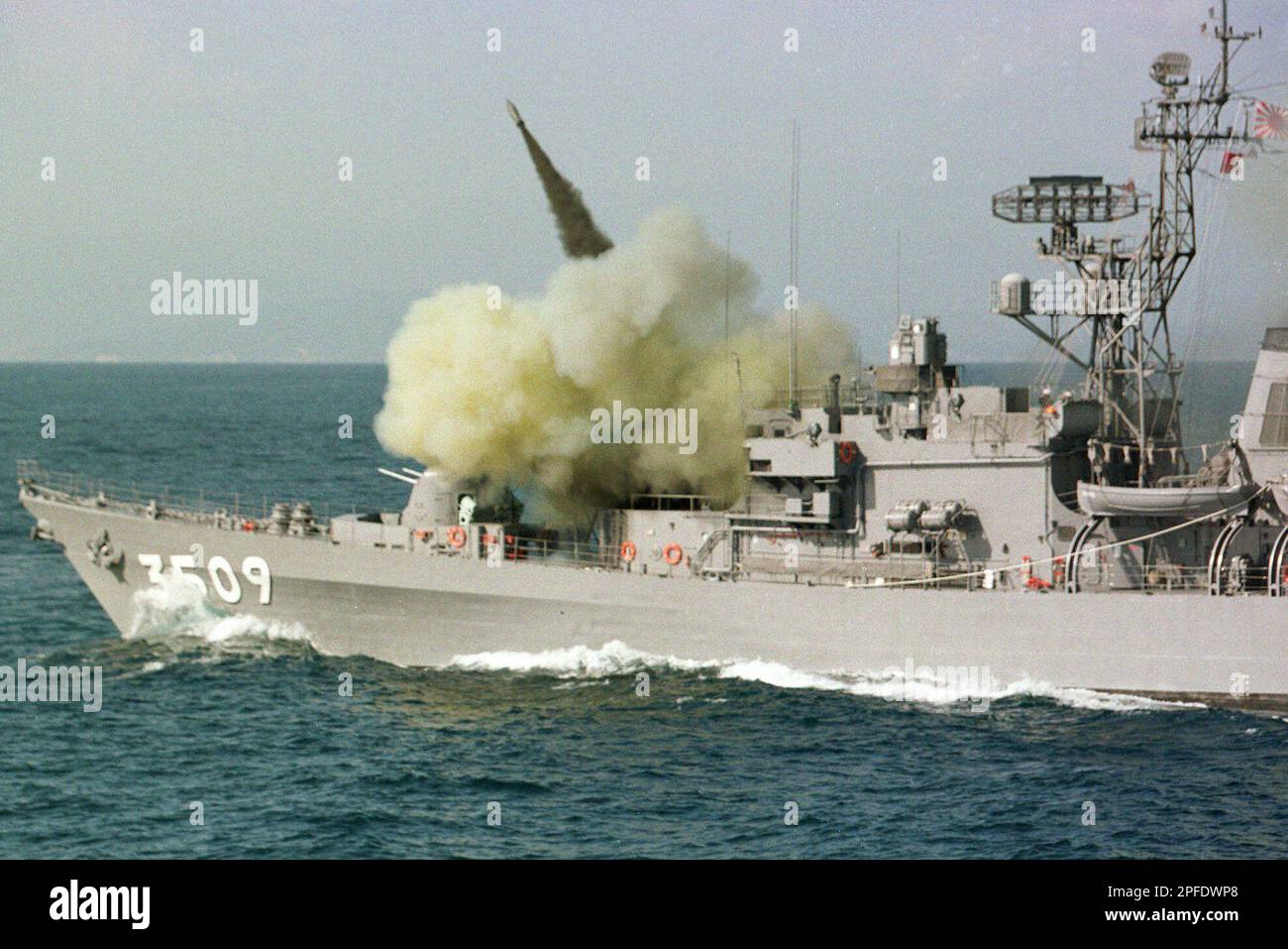 Training ship Minegumo fires a rocket during a review of the fleet of ...