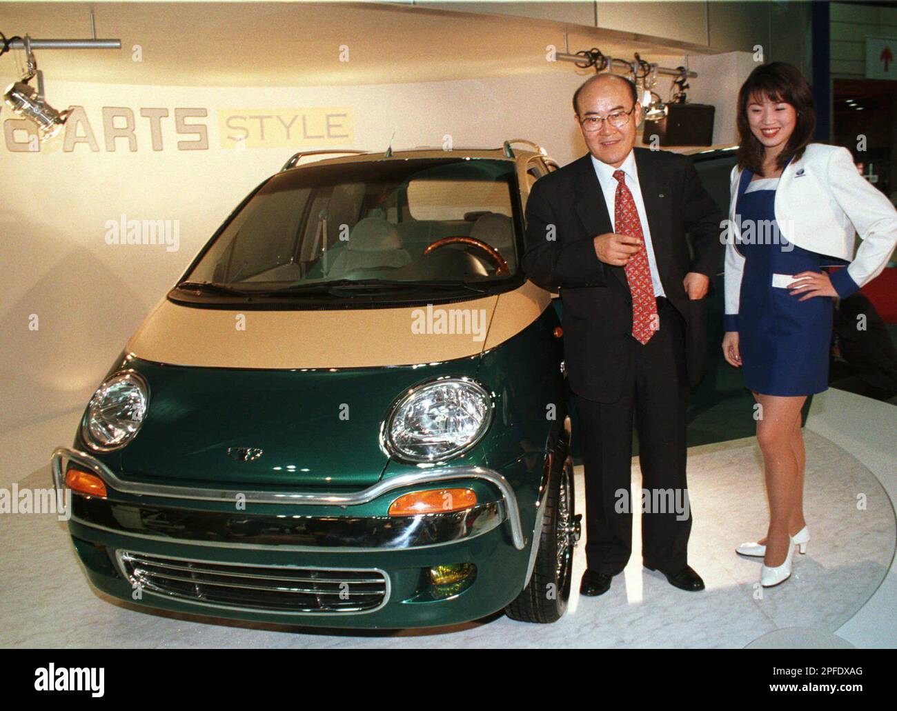 Daewoo Motors' Chairman Kim Tae-gu poses with a model and his automaker ...