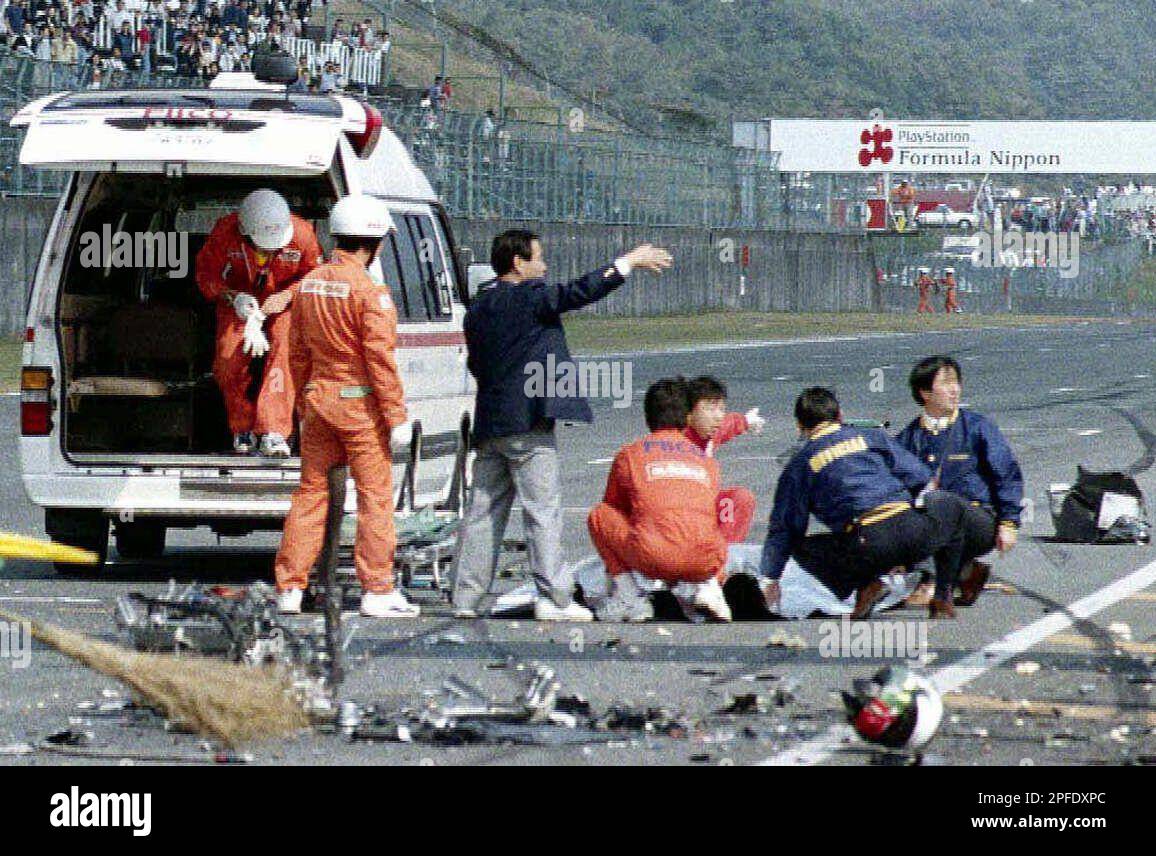 Course officials and rescue workers attend Japanese racing car driver ...