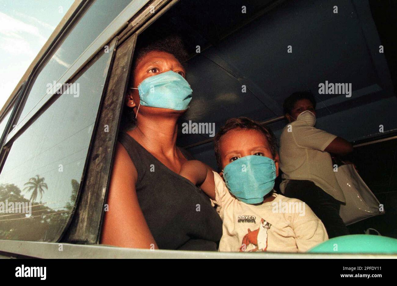 Ines Oliver and her son Williams Oliver, 2, wear masks to protect them ...
