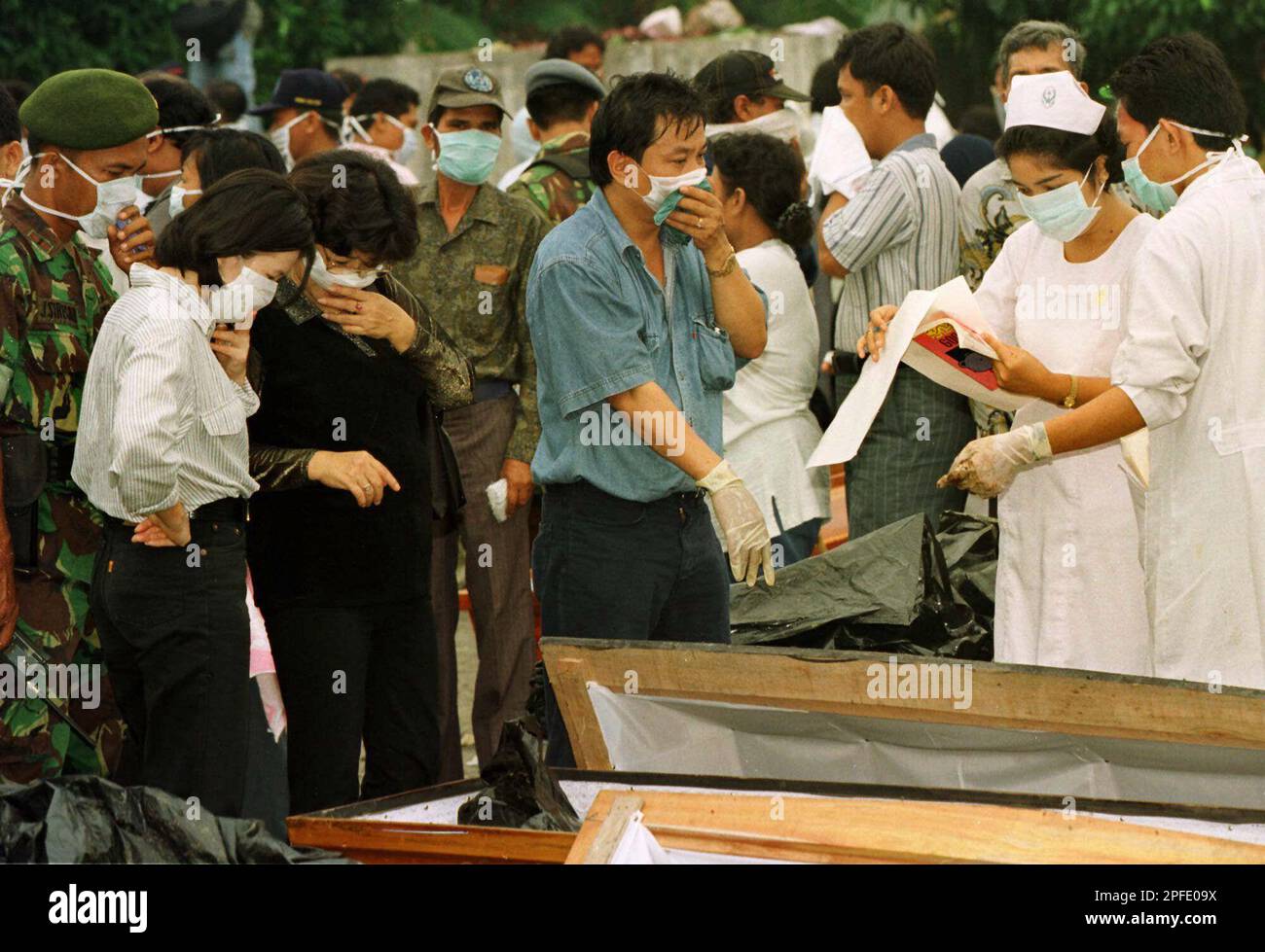 Doctors help relatives of victims of the Garuda plane crash identify ...