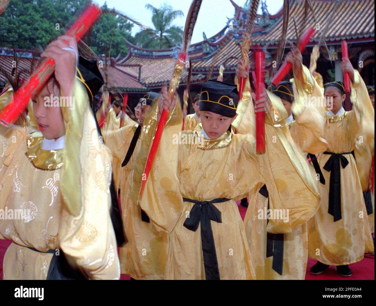 Schoolboys in ancient Chinese costumes perform a ritual dance at Taipei ...