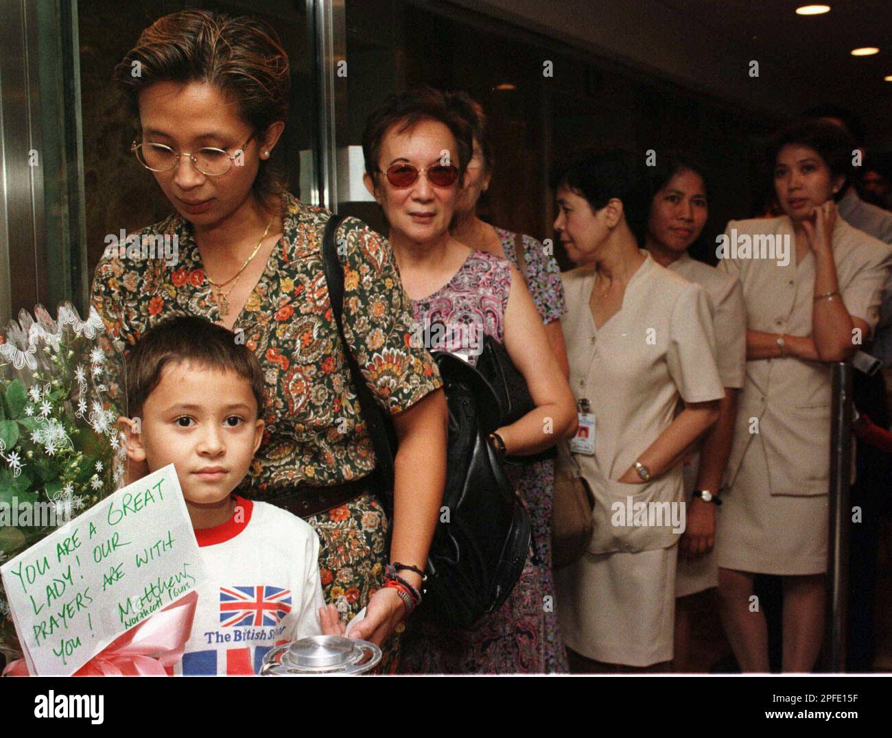 Matthew Northcott, lead by his mother in a queue of sympathizers ...