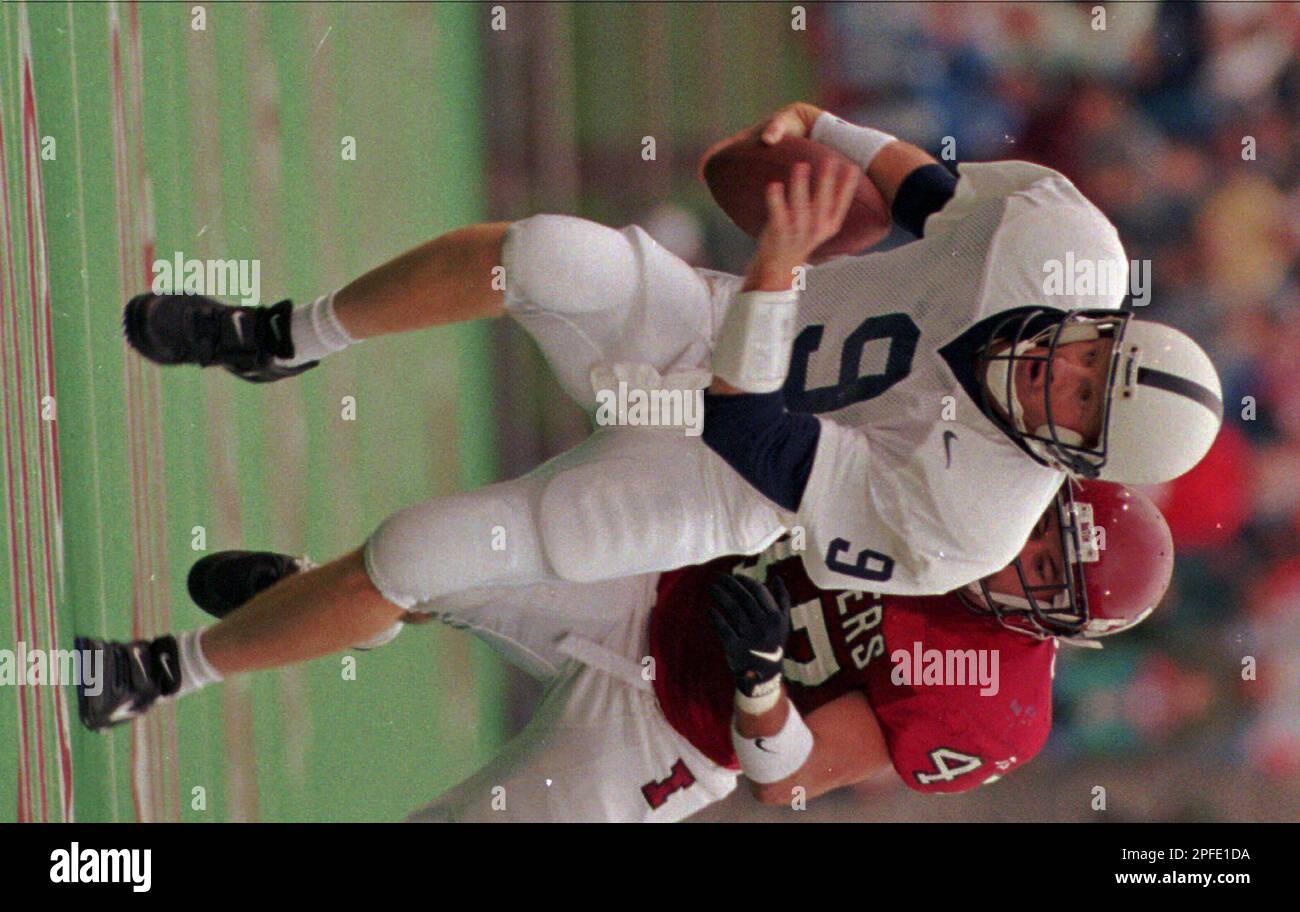 Penn State quarterback Mike McQueary (9) eludes the tackle of Indiana's ...