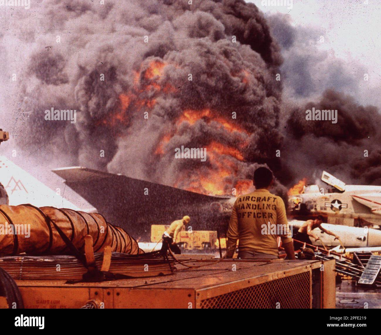 The USS Forrestal with burning planes on deck, is shown in this 1967 ...