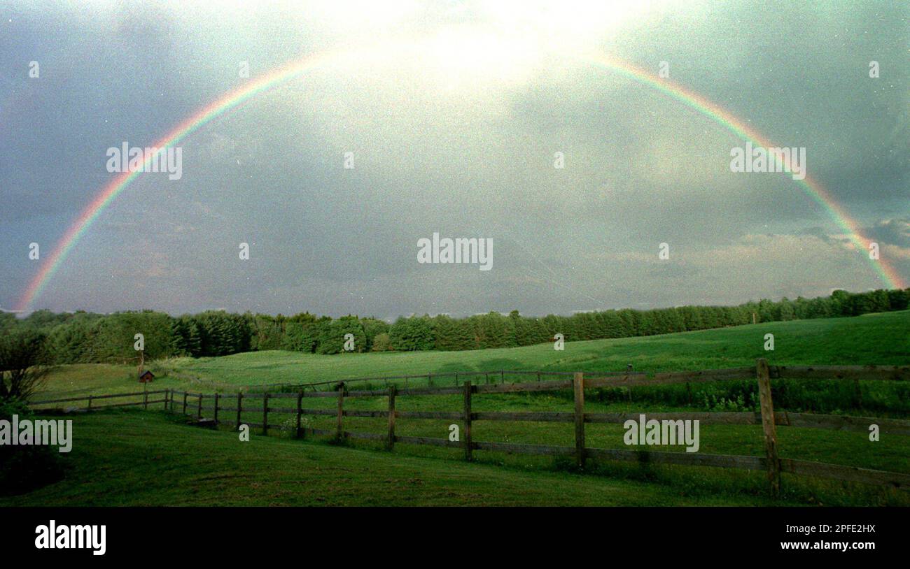 A rainbow arches over a field in Calais, Vt., Monday, July 7, 1997 ...