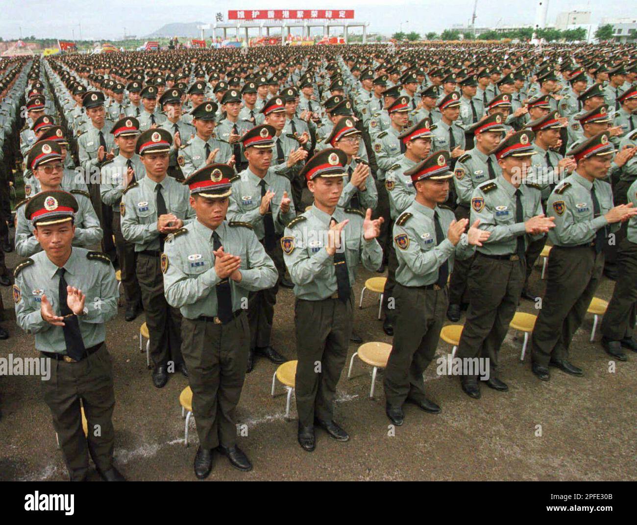 Soldiers of China's People Liberation Army applaud in formation Monday ...