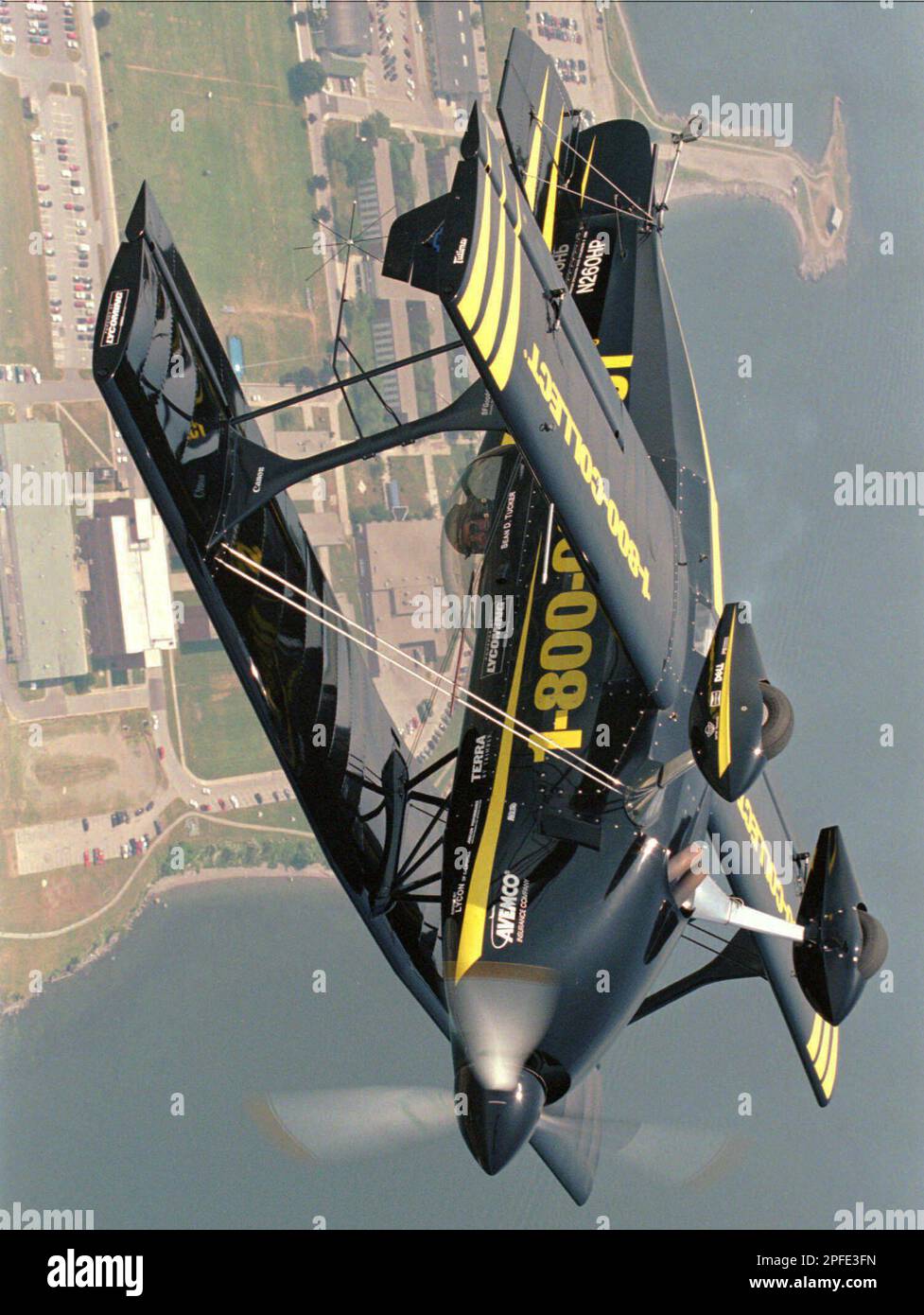 Sean D. Tucker flies his aerobatic biplane upside-down over ...