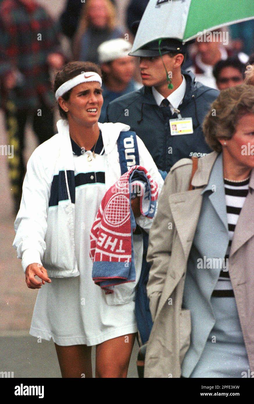 Mary-Joe Fernandez is escorted back to the dressing room, during a rain ...