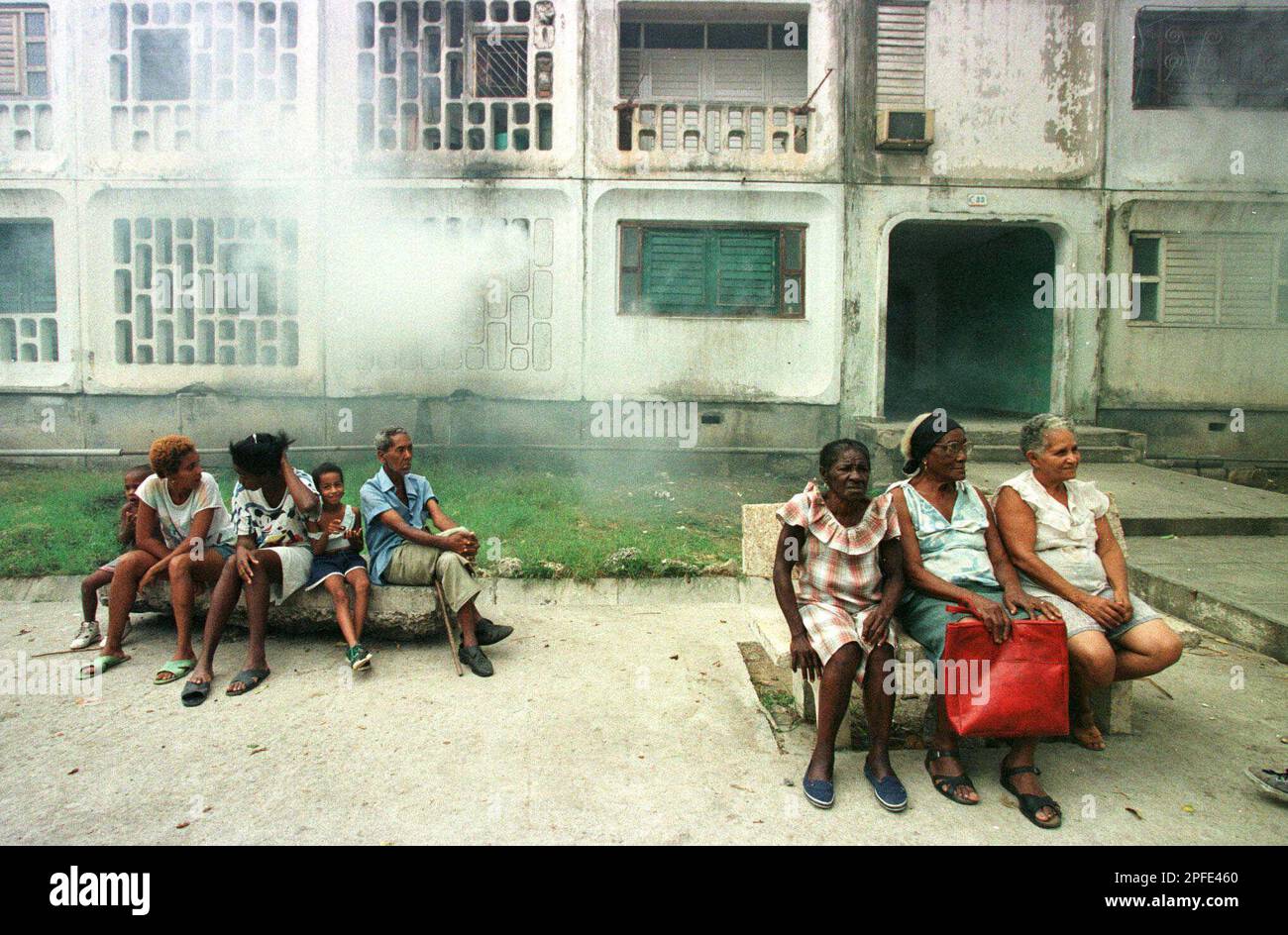 A fog of insecticide billows from an apartment building in Santiago ...
