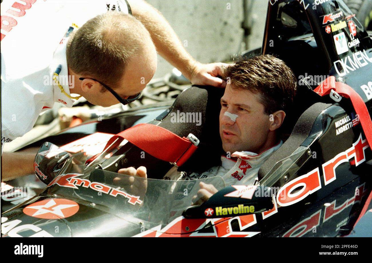 Michael Andretti confers with mechanic Ty Manseau during a break in the ...