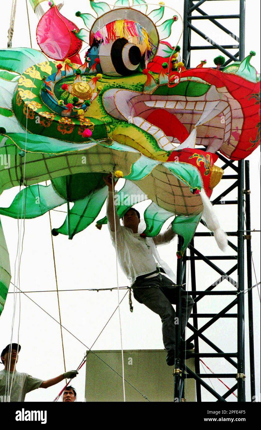 A dragon paper float is being set up on a scaffolding Wednesday, June ...