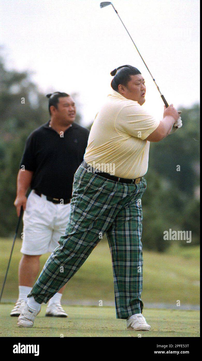 Japanese Sumo Wrestlers Mitoizumi Masayuki (right) plays his shot as he ...
