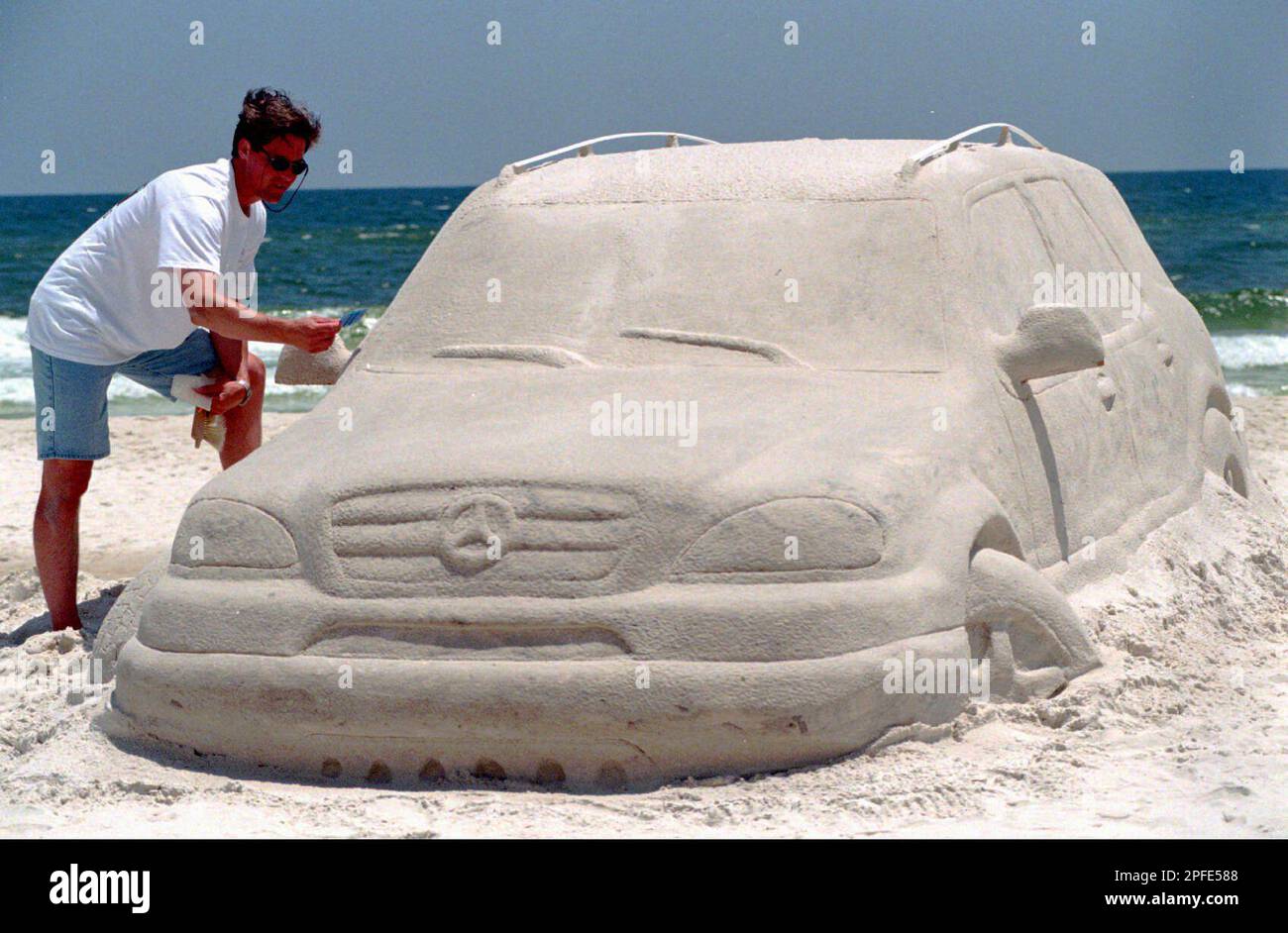 Spencer Till of Lewis Advertising in Mobile, Ala. shapes up the sand ...