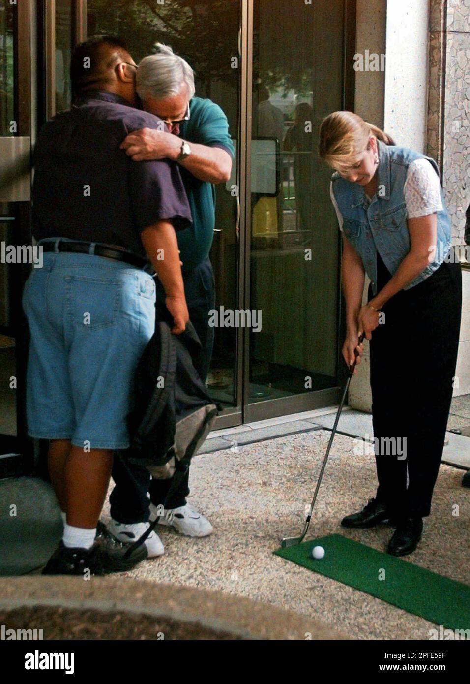 Rudy Guzman, left, and Roy Sells hug as Diahanna Anderson practices her ...