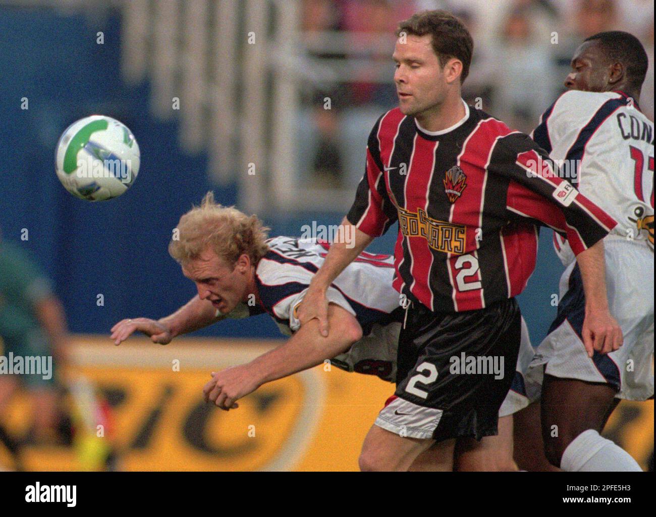 New England Revolution forward Paul Keegan heads the ball past New York ...
