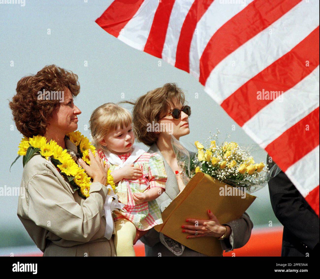 From left, Linda Finch holds her two-year-old adopted daughter Katie ...