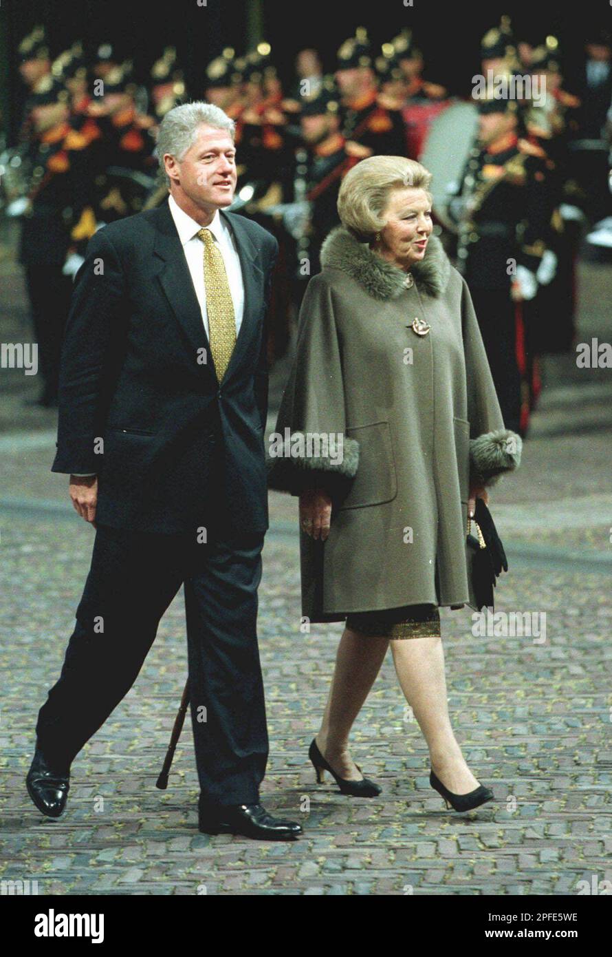 U.S. President Bill Clinton and Dutch Queen Beatrix review the honor ...