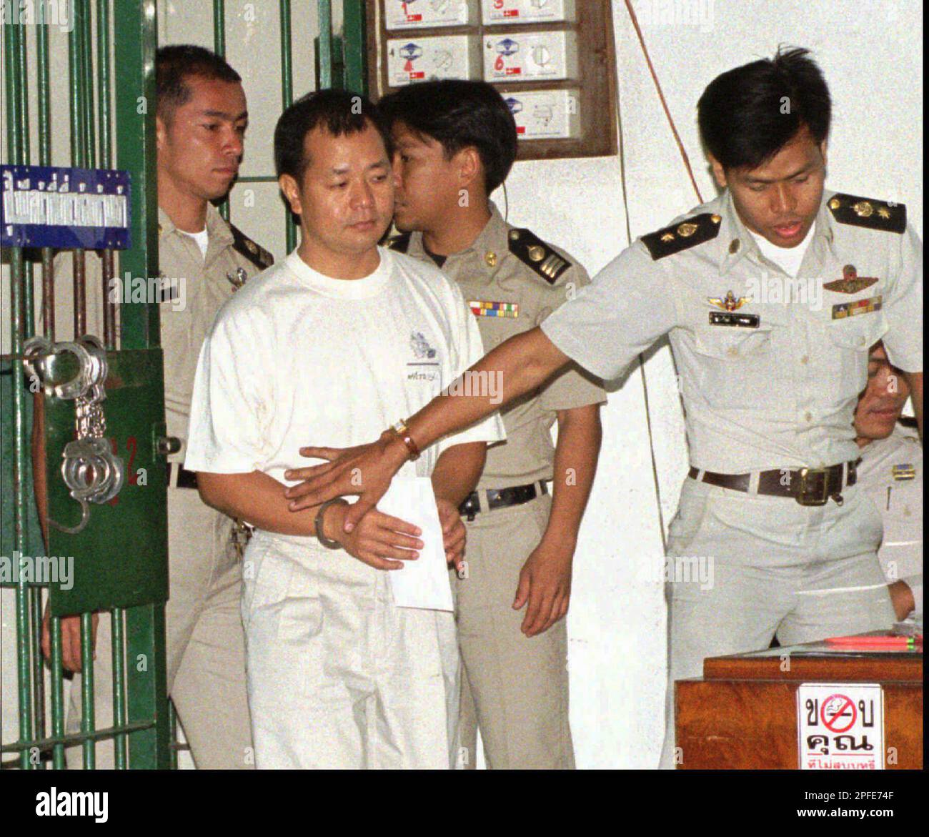 Heroin drug-trafficking suspect Li Yun Chung, center, is led by ...