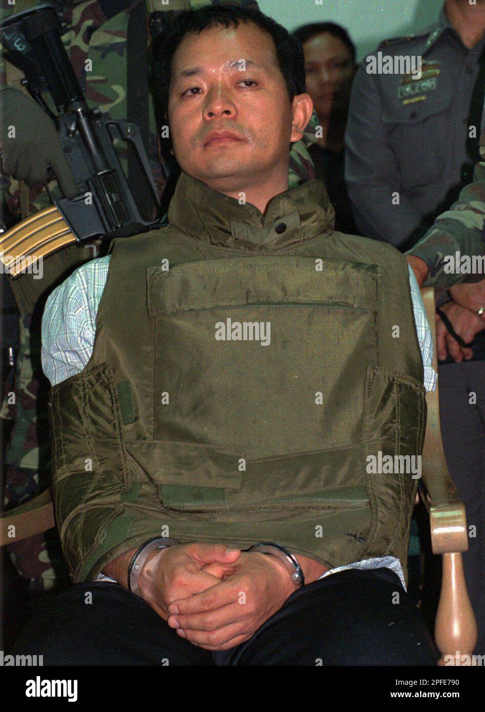 Handcuffed Li Yun Chung sits for a news conference upon arrival at ...