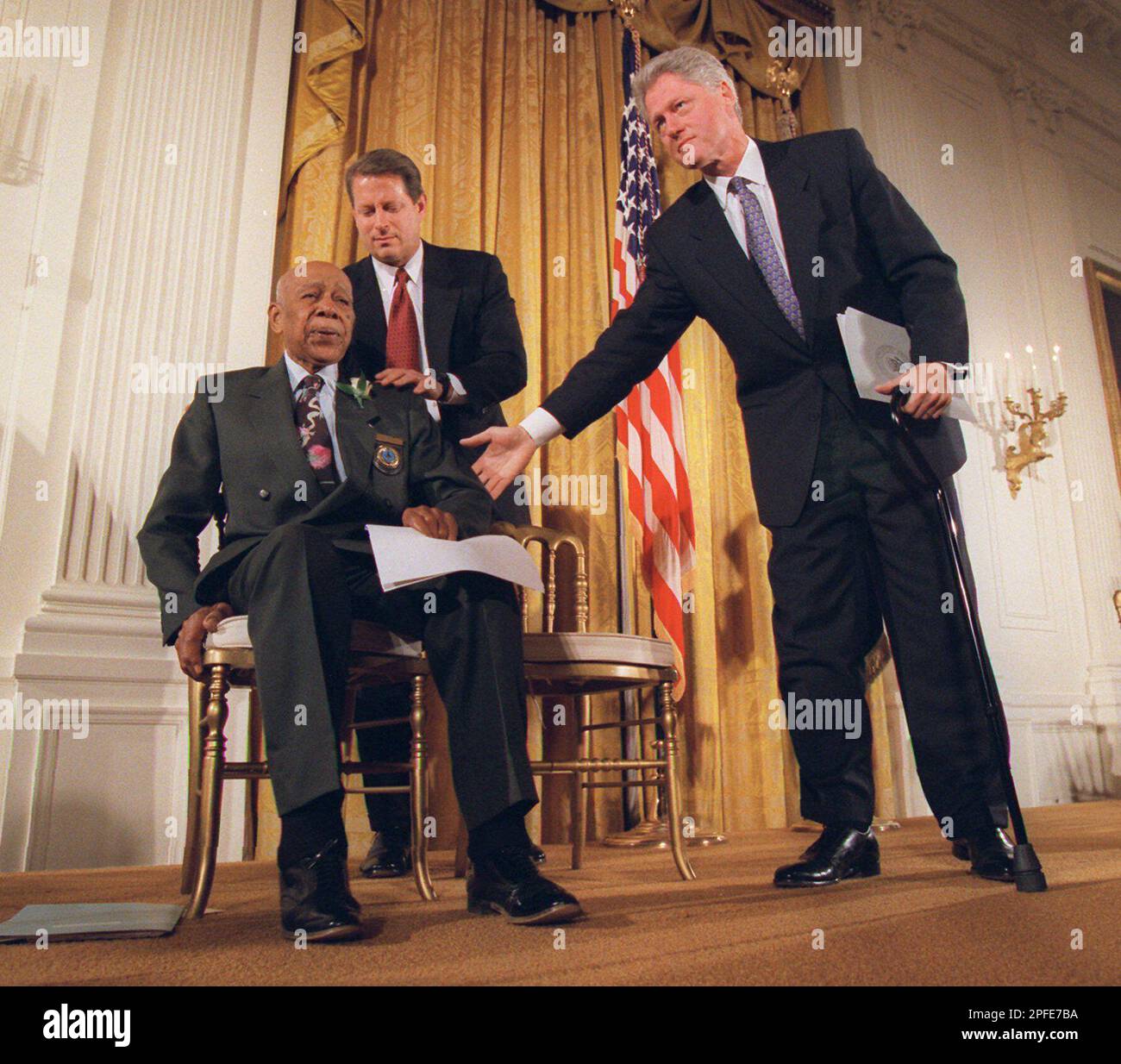 President Clinton and Vice President Al Gore, back, help Herman Shaw ...