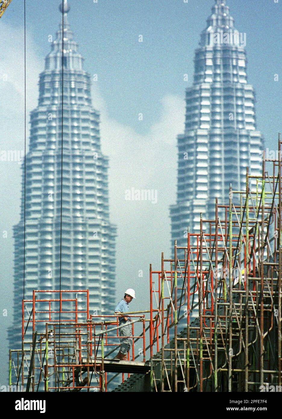 The world's tallest towers, the Petronas Towers, loom over a nearby ...