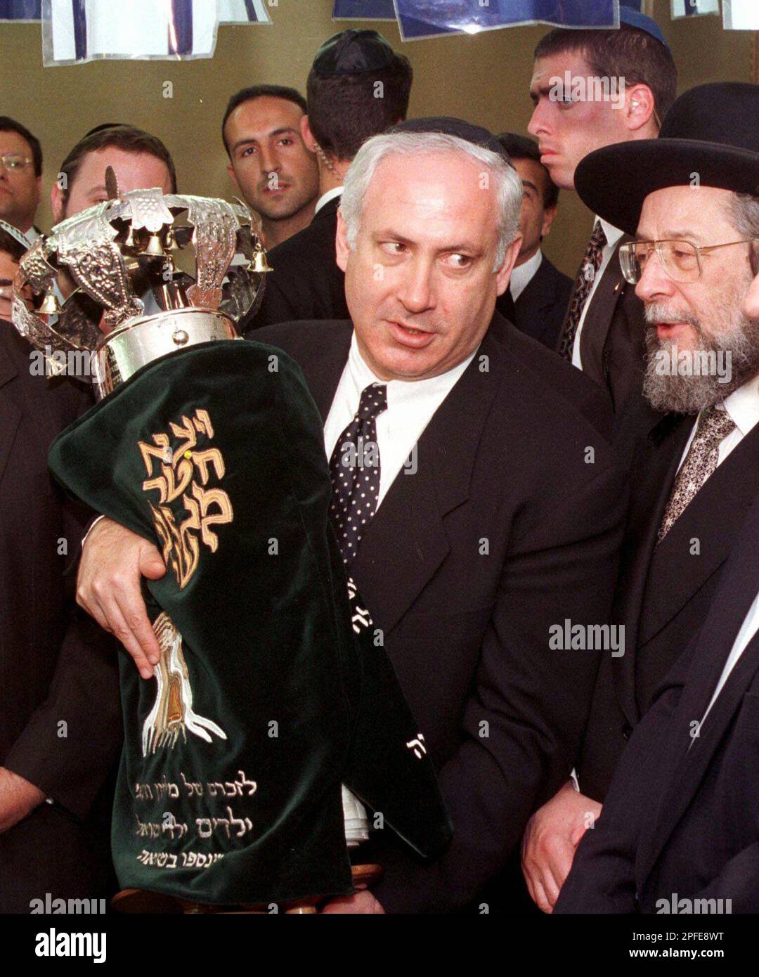 Israeli Prime Minister Benjamin Netanyahu holds the Torah while ...