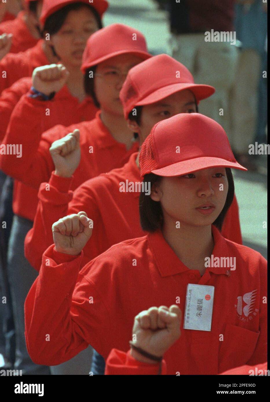 A group of eighteen year-old students from Hong Kong make a pledge of ...