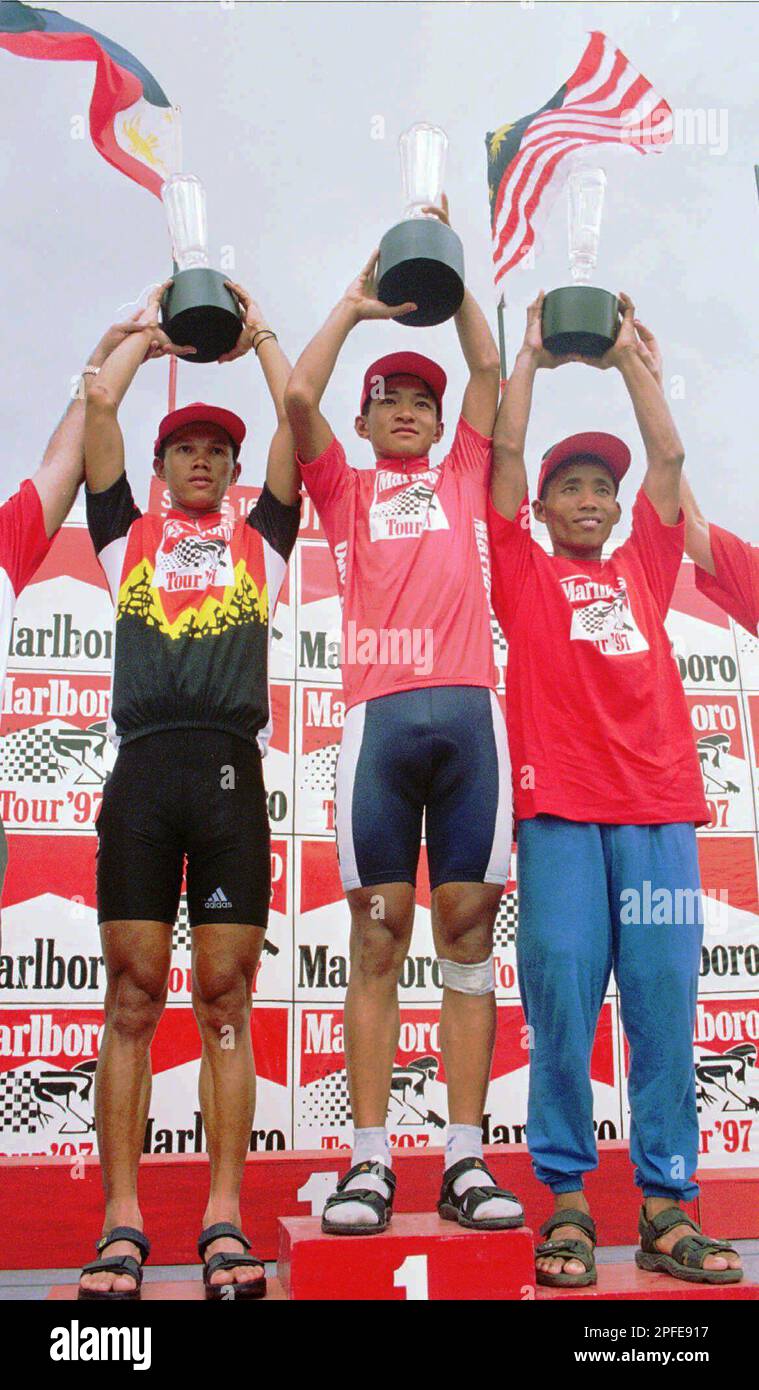 Wong Kam Po, center, of Hong Kong raises the trophy Sunday, May 4, 1997 ...