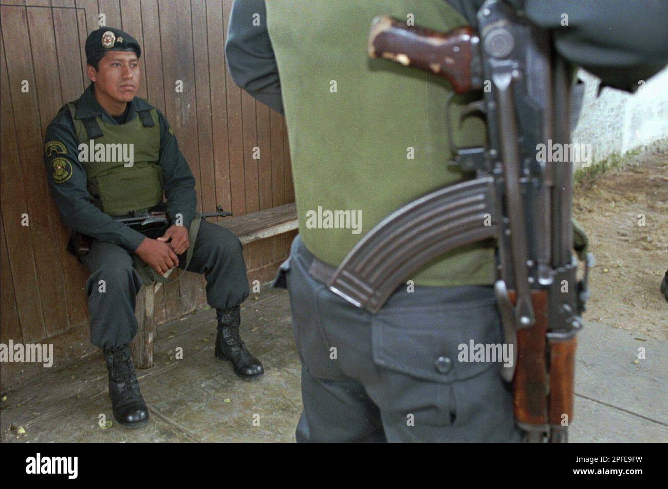 A Peruvian police officer takes a break while guarding the house of the ...