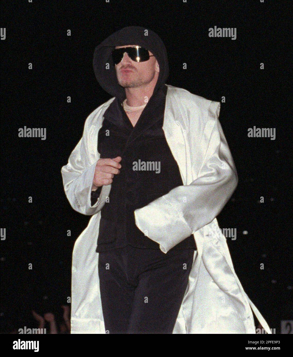 Lead vocalist Bono of the rock group U2 walks to the stage to sing his ...