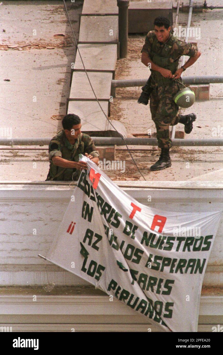 Peruvian soldiers remove a banner of the Tupac Amaru Revolutionary ...