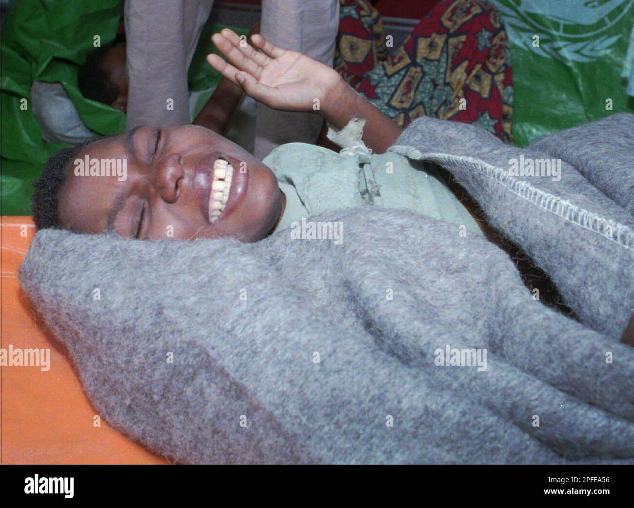 A Hutu Refugee in pain at Goma airport, after she and 27 others were ...