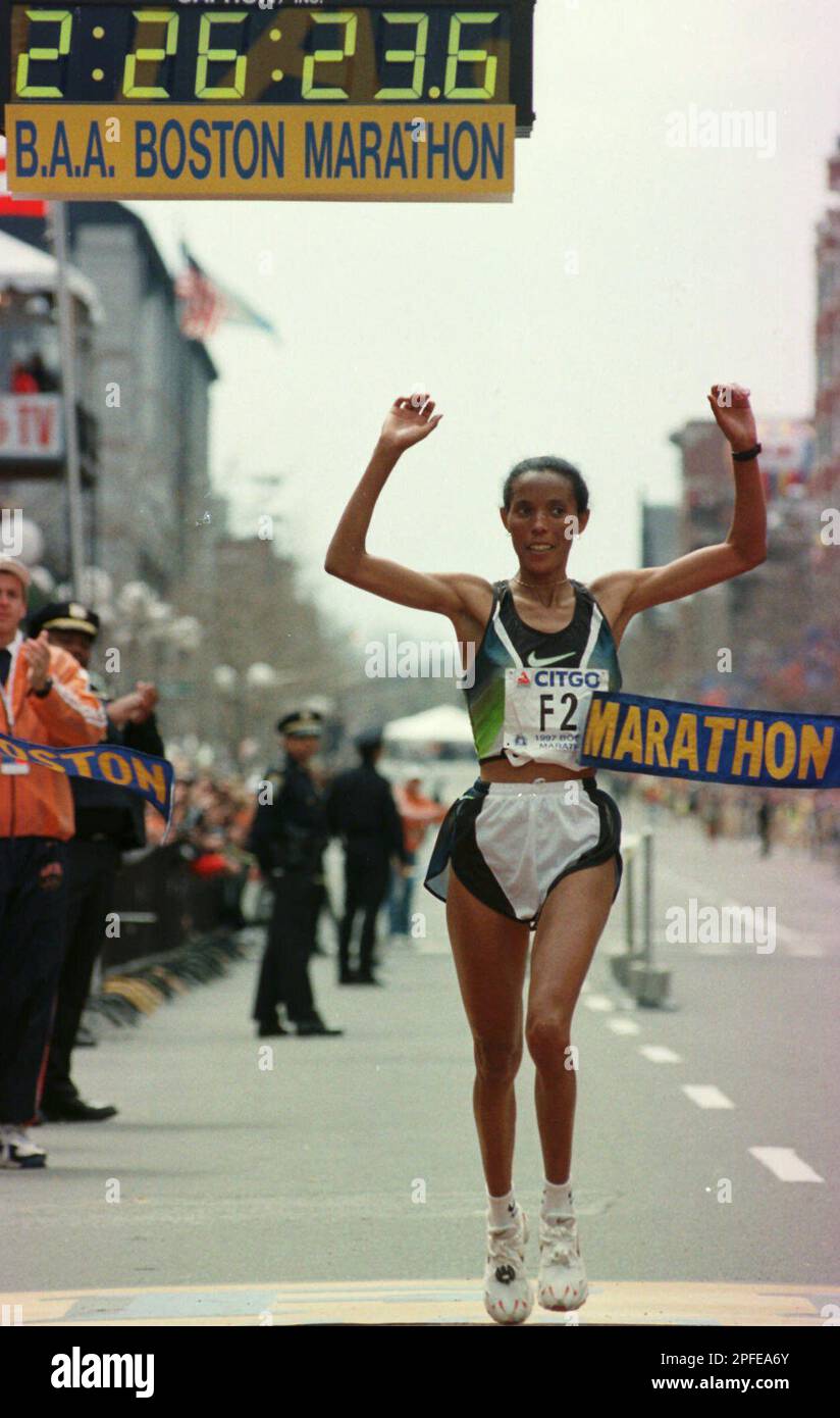 Fatuma Roba of Ethiopia breaks the tape as she crosses the finish line ...