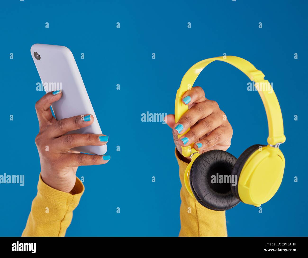 Closeup, hands and smartphone with headphones, streaming music and ...